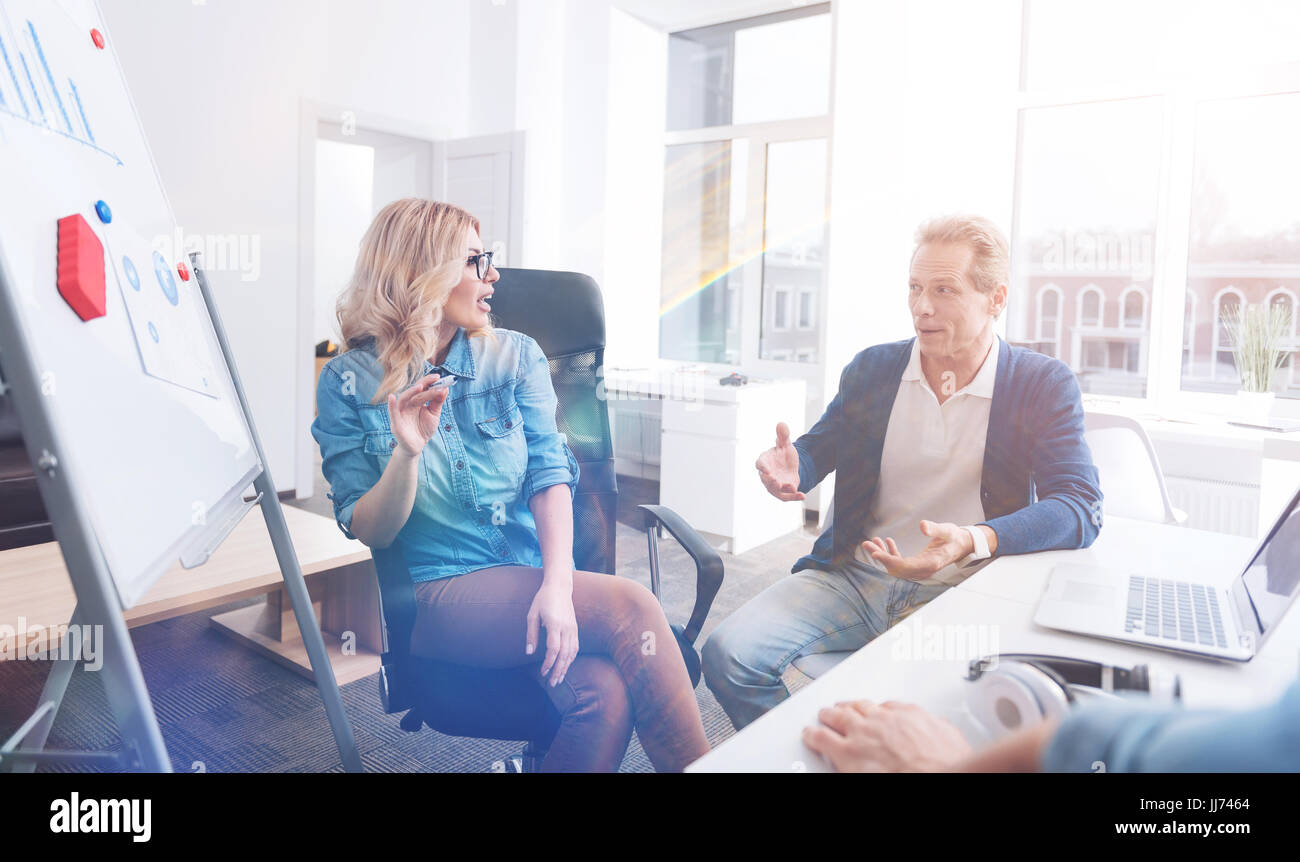 Emotional professional colleagues having discussion in the office Stock ...