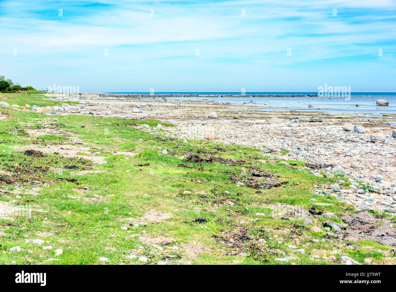 Limestone beach with long limestone pier. Horizon over water Stock ...