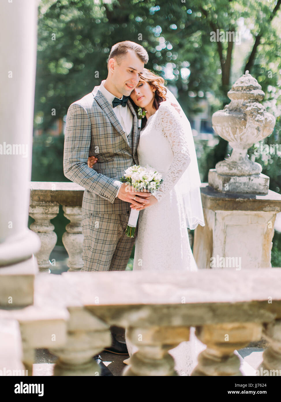 The romantic portrait of the happy bride leaning on the shoulder of the ...