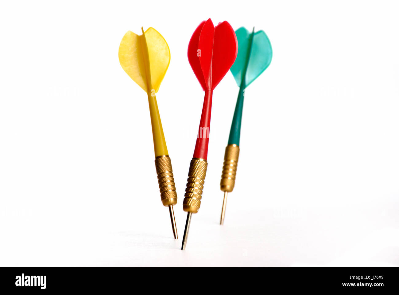 three colourful darts isolated Stock Photo - Alamy