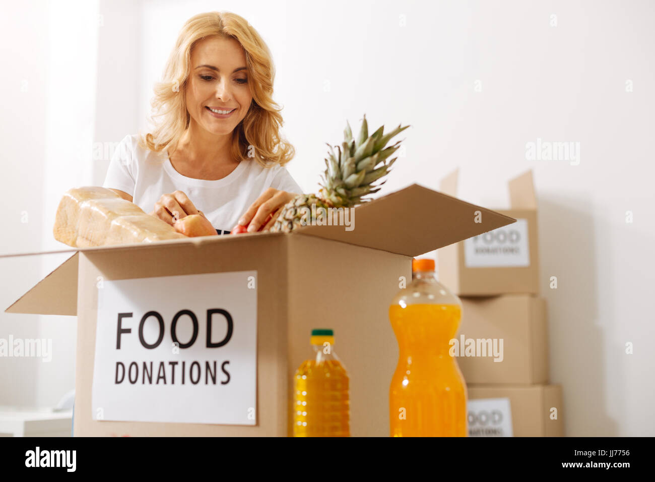 Classy enchanting woman checking the contents of a box Stock Photo - Alamy