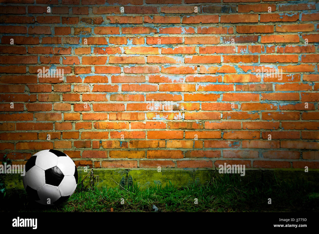 football ball against a bricks wall Stock Photo - Alamy