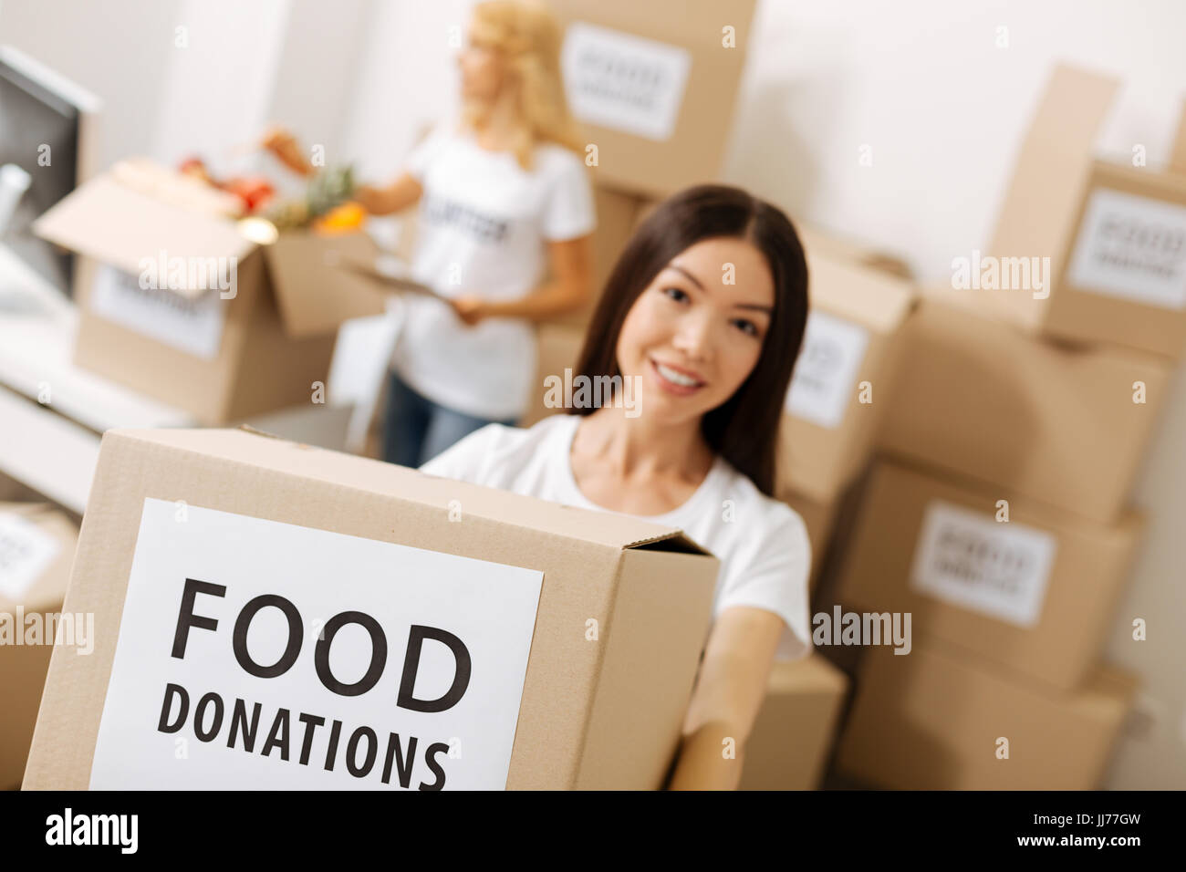Beautiful admirable woman helping needy people Stock Photo - Alamy