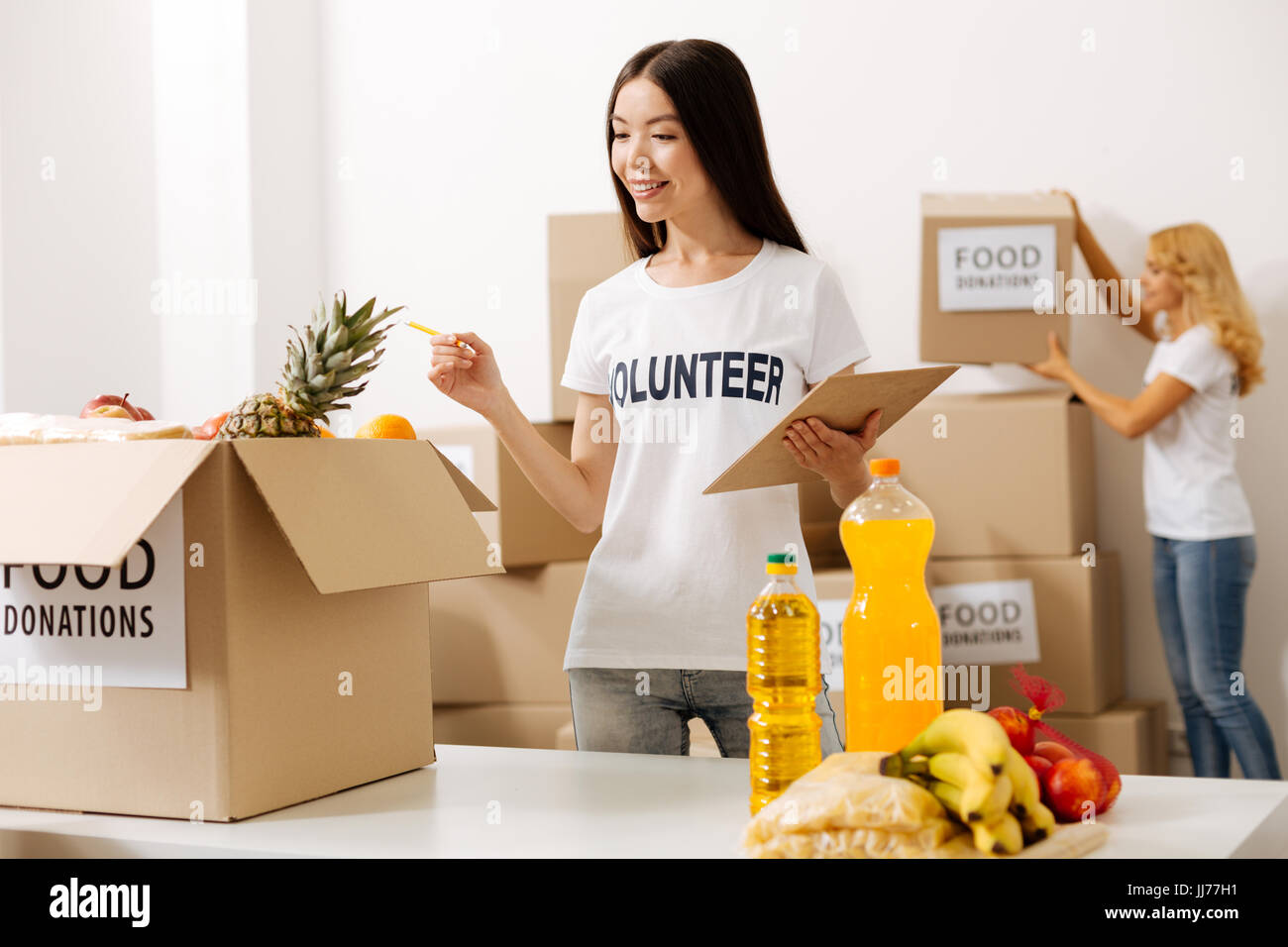 Capable intelligent woman examining the contents of the box Stock Photo ...