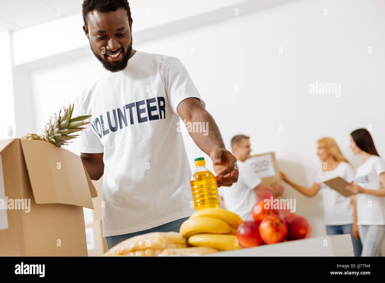 Nice enthusiastic man happy helping for free Stock Photo - Alamy