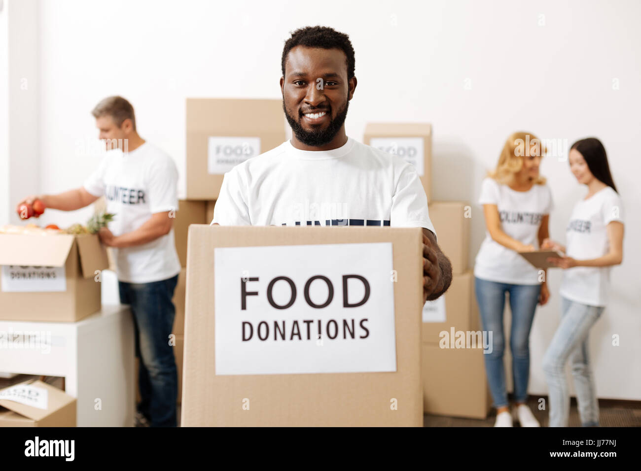 Generous lively man happy helping others Stock Photo - Alamy