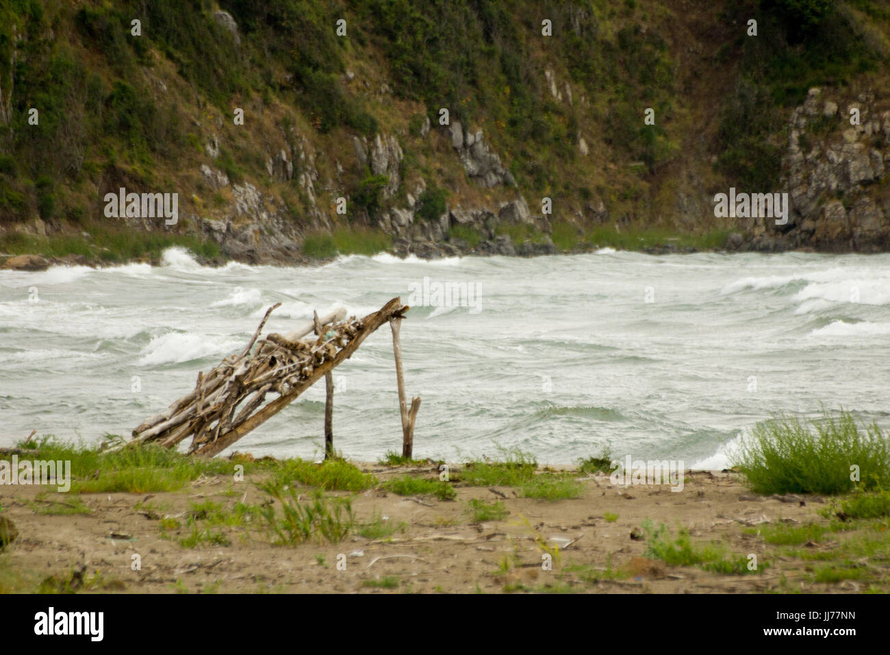 SHELTER ON A STRANDED BEACH WITH ROCKY SURROUNDING Stock Photo - Alamy