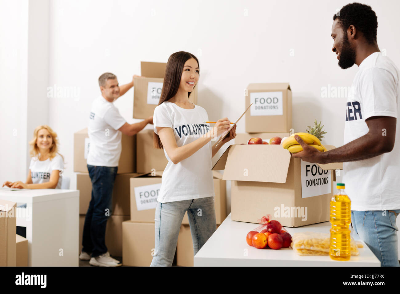 Dedicated clever lady revising the contents of the parcels Stock Photo ...