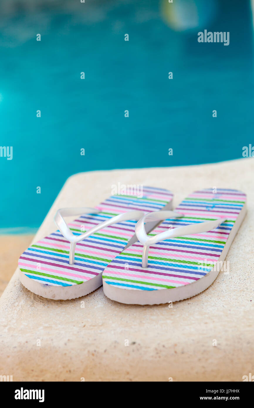 Color flip-flops near to the pool Stock Photo - Alamy