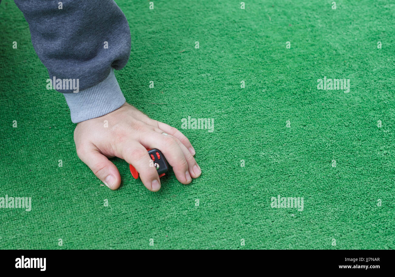 Little blonde girl holding a fidget cube stress relieving object ...