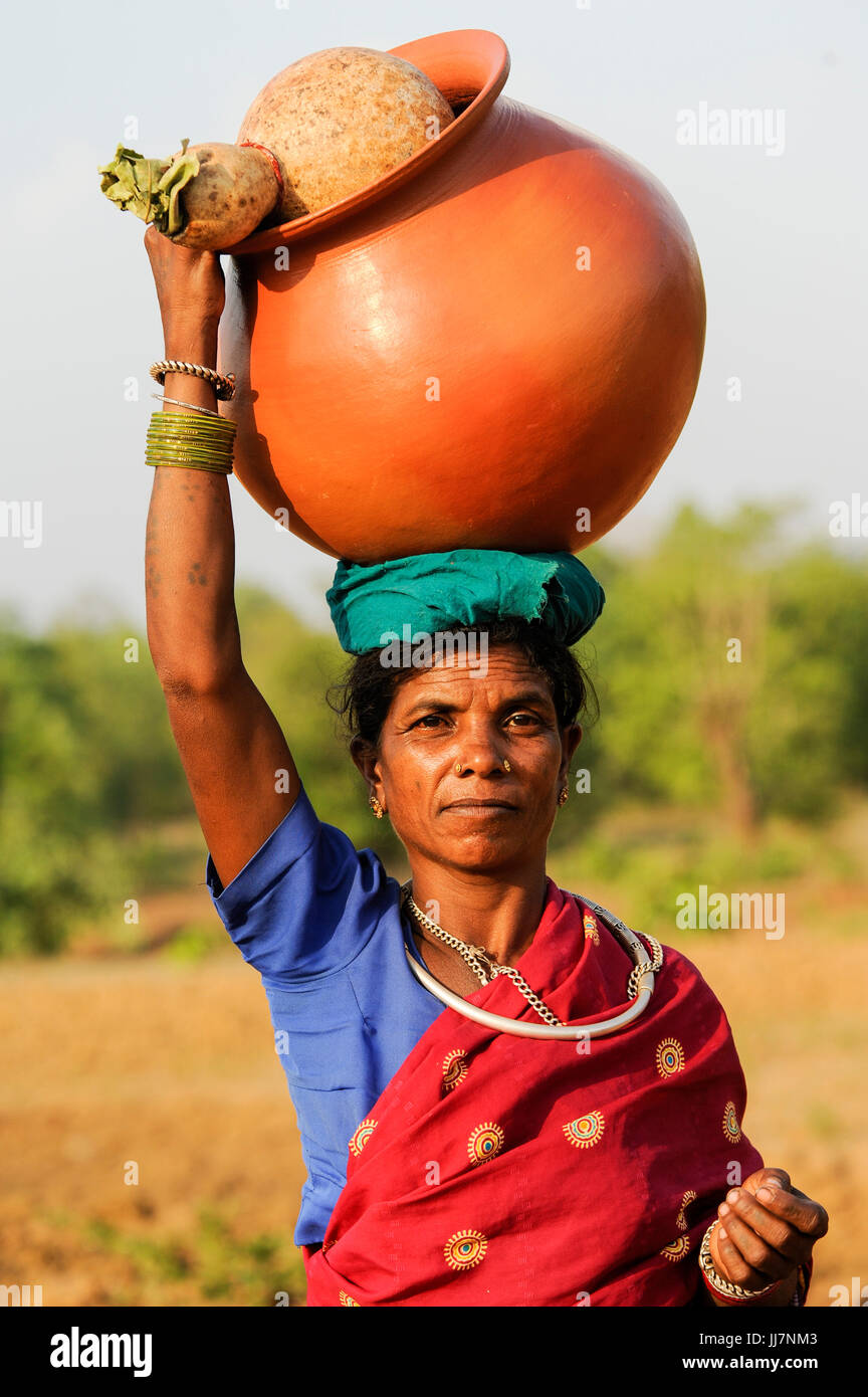 INDIA Chhattisgarh, Bastar, tribal Gond woman with clay pot coming from ...