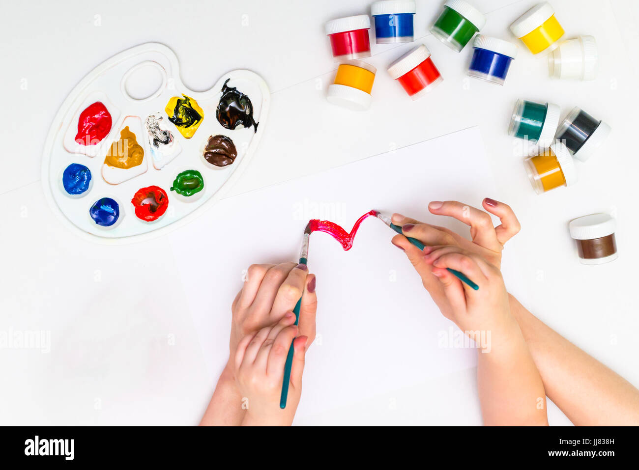 Child's hands painting a heart Stock Photo - Alamy