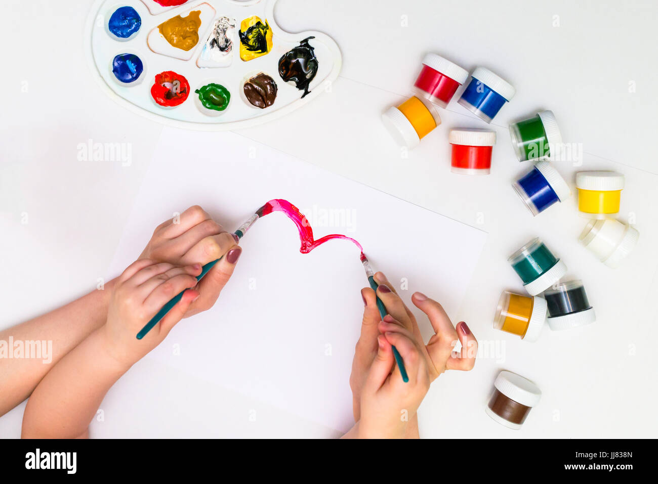Child's hands painting a heart Stock Photo - Alamy