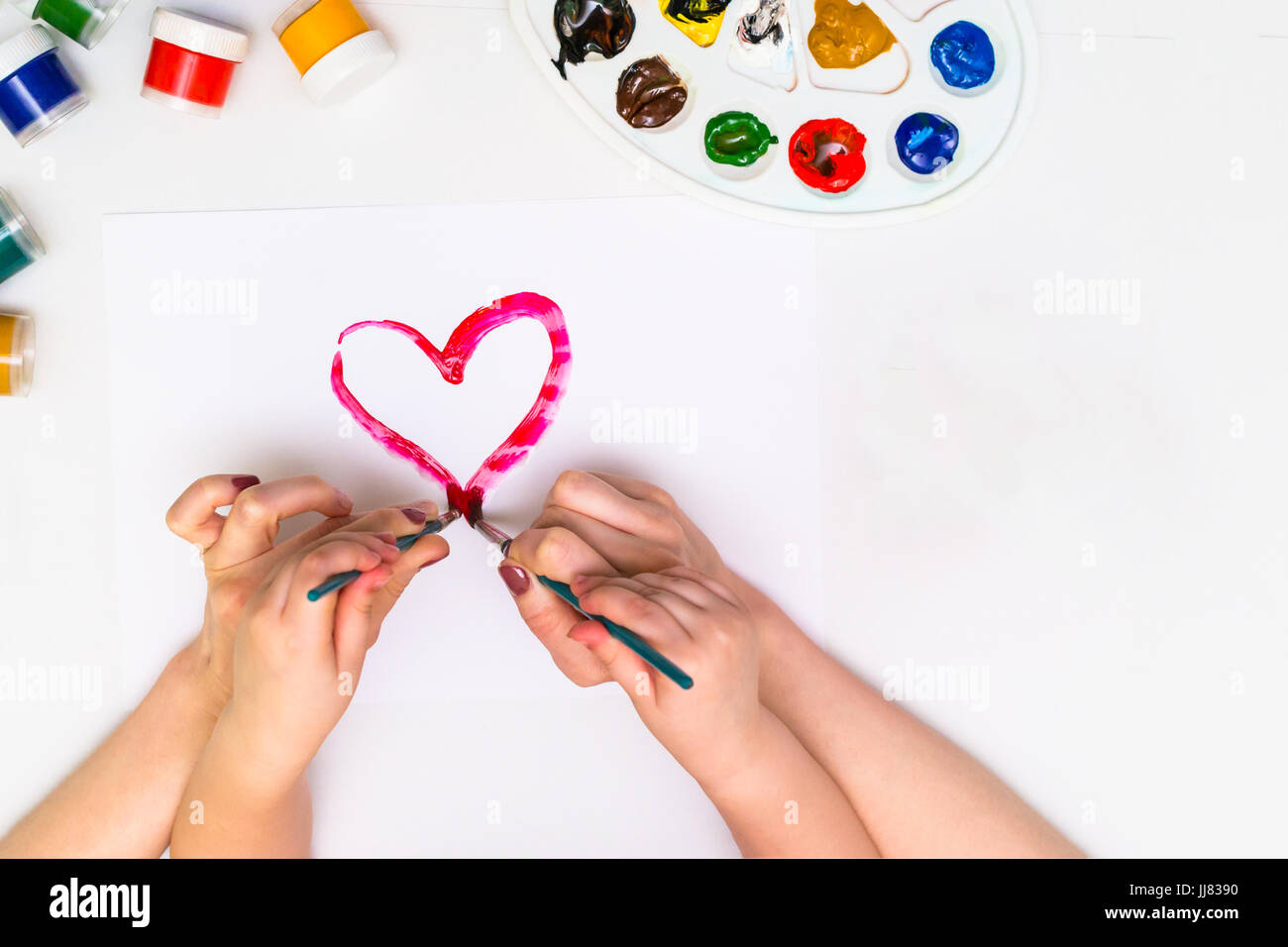 Child's hands painting a heart Stock Photo - Alamy