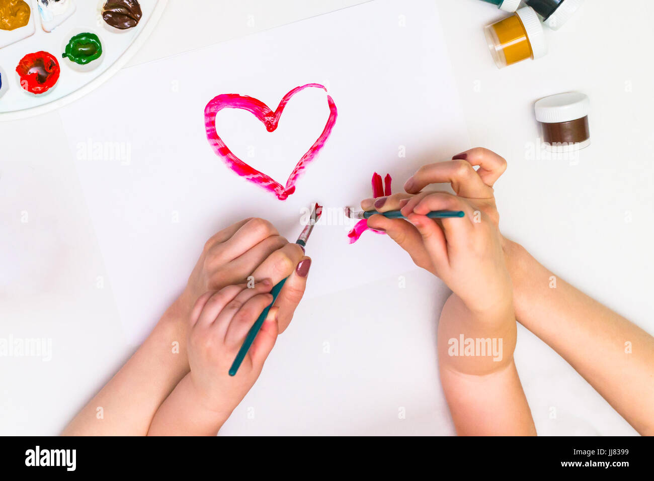 Child's hands painting a heart Stock Photo - Alamy