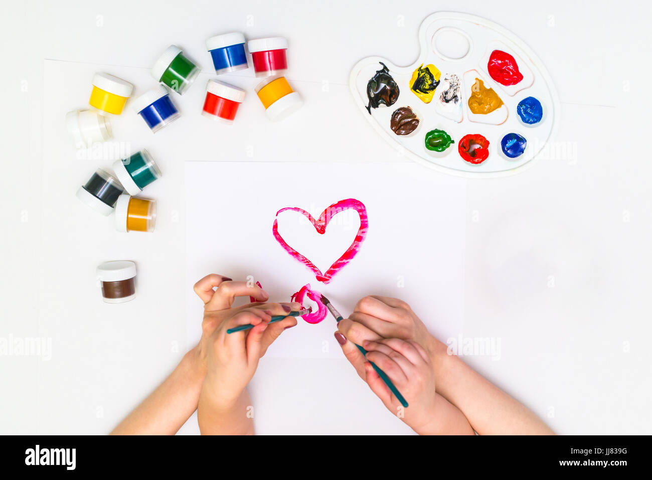Child's hands painting a heart Stock Photo - Alamy