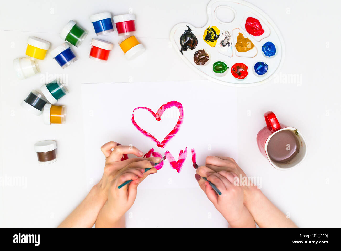 Child's hands painting a heart Stock Photo - Alamy