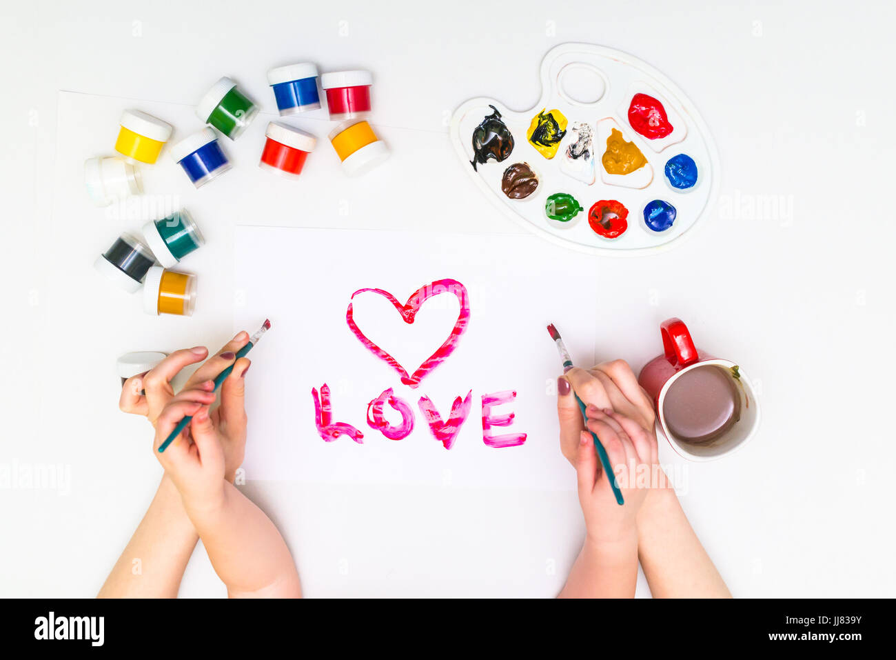 Child's hands painting a heart Stock Photo - Alamy