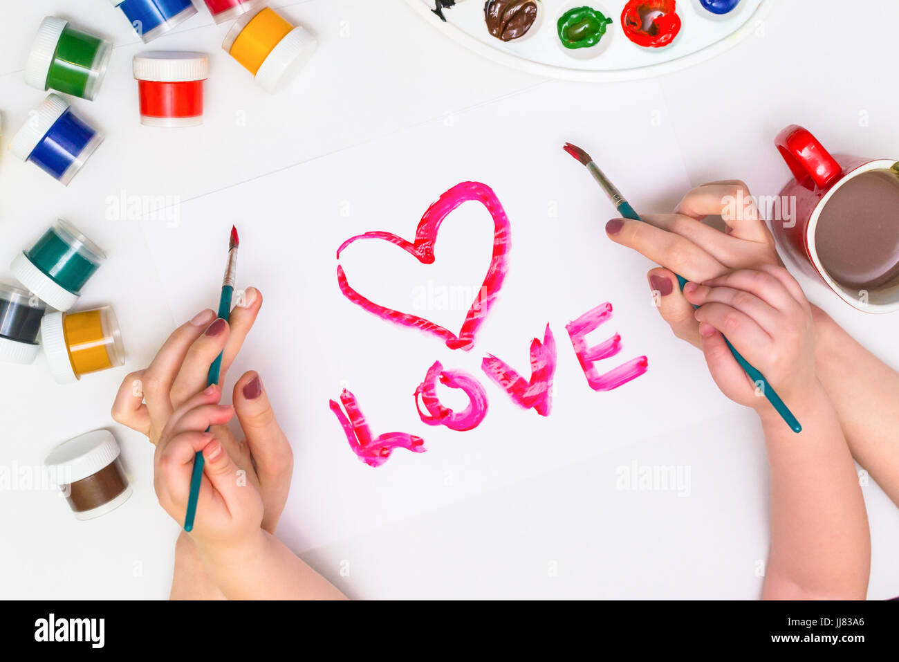 Child's hands painting a heart Stock Photo - Alamy