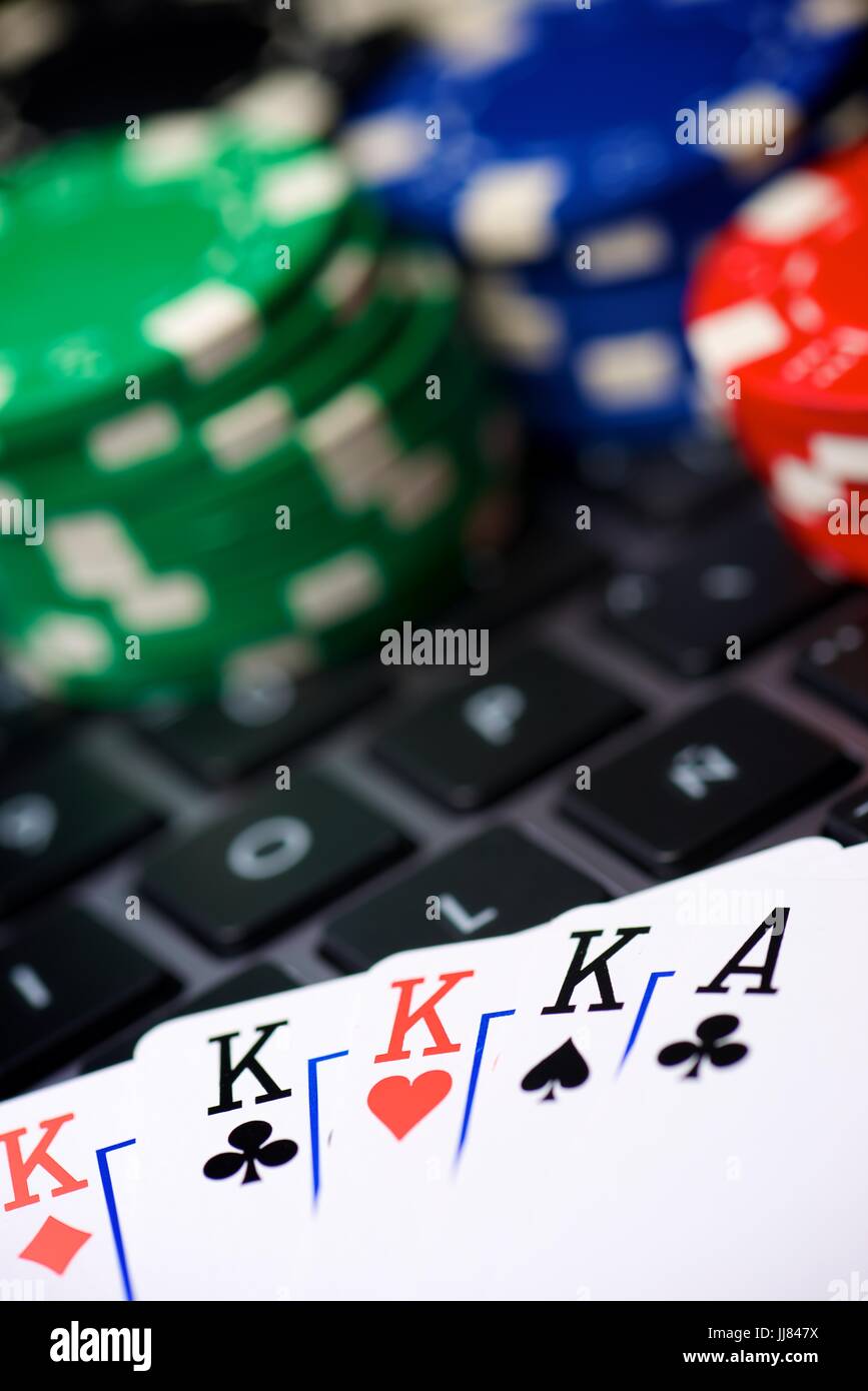 Casino chips and cards stacking on a laptop Stock Photo - Alamy