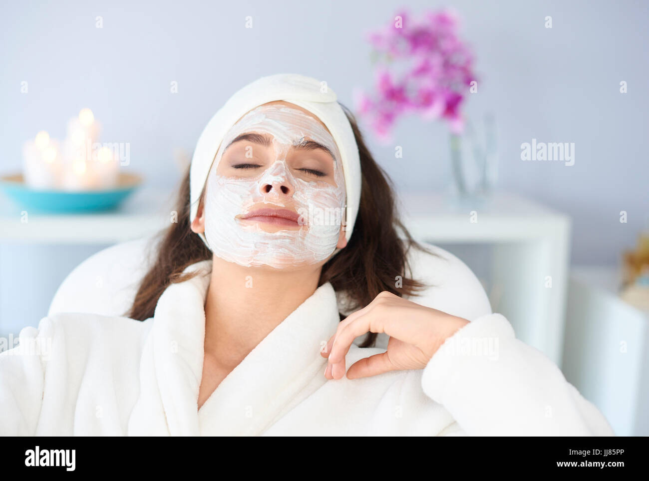 Relaxed woman is getting a face mask in spa Stock Photo - Alamy