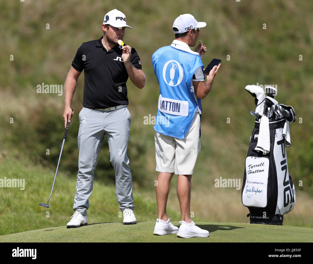 England's Tyrrell Hatton and caddie enjoy an ice cream during practice ...