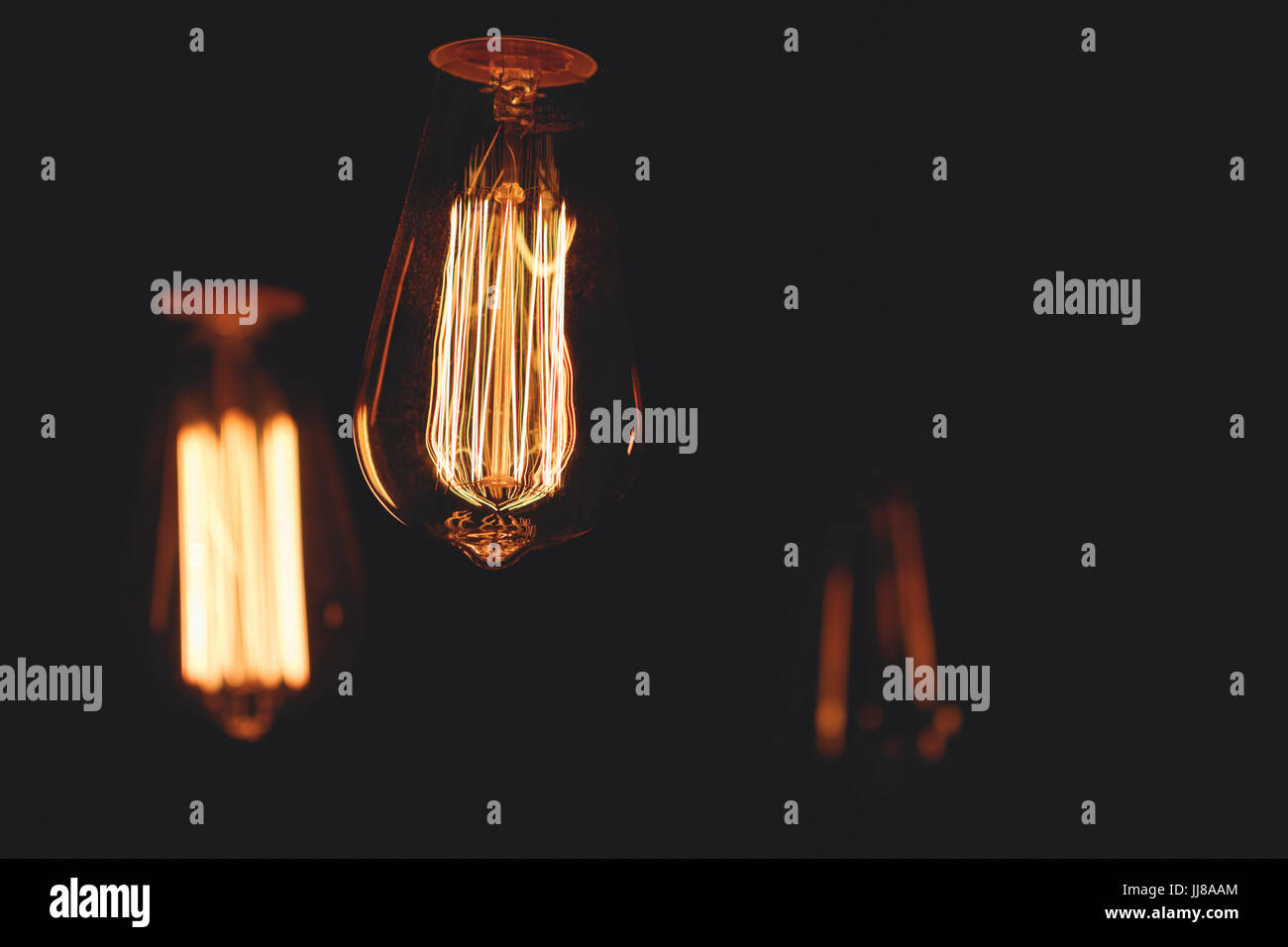 Close-up of glowing retro light bulbs on a black background Stock Photo ...