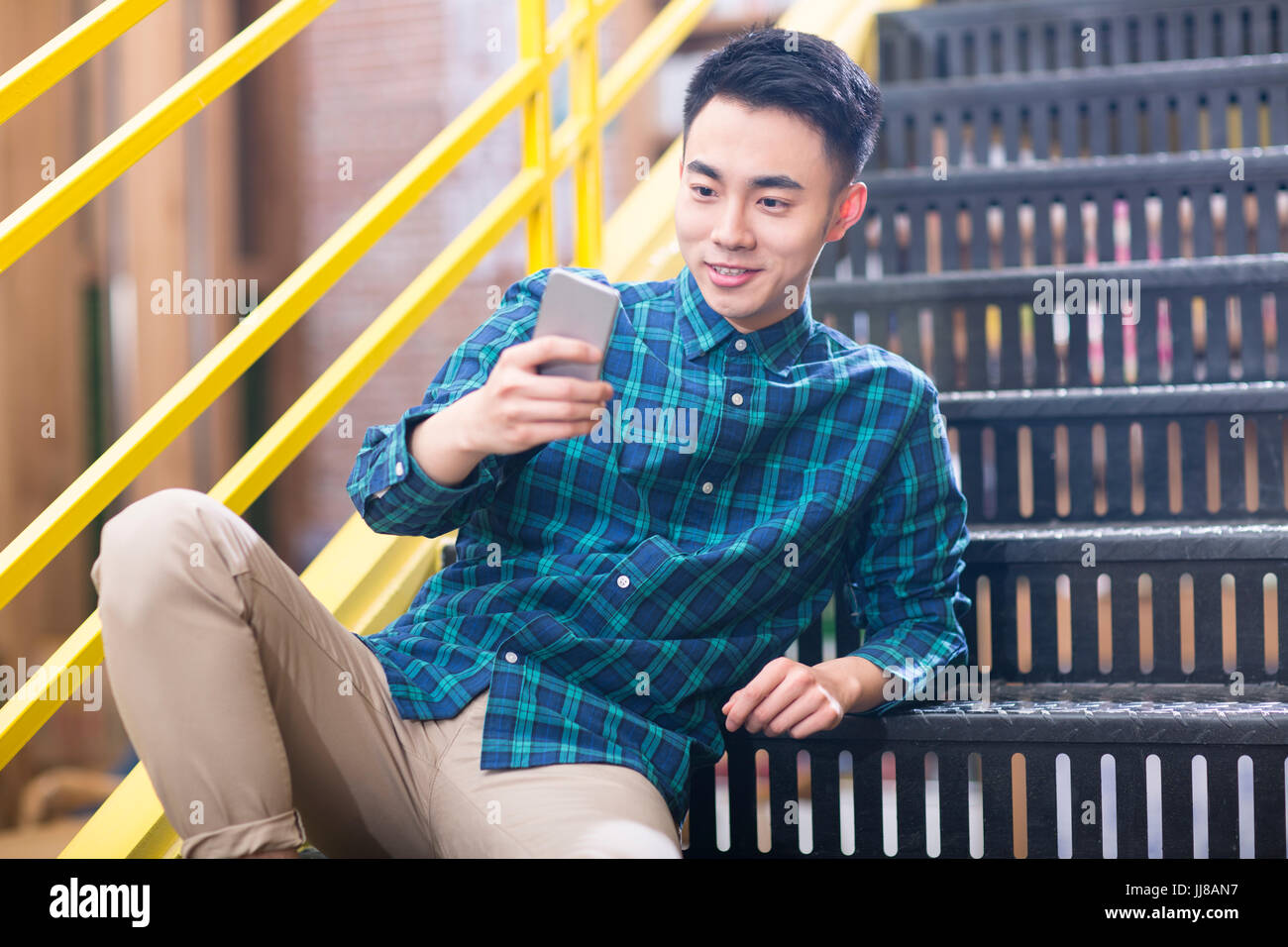 Young man using cell phone Stock Photo - Alamy
