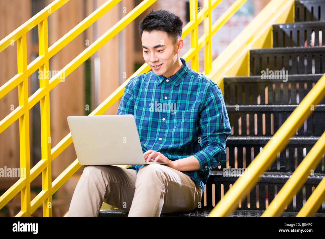 Young man work on the stairs Stock Photo - Alamy