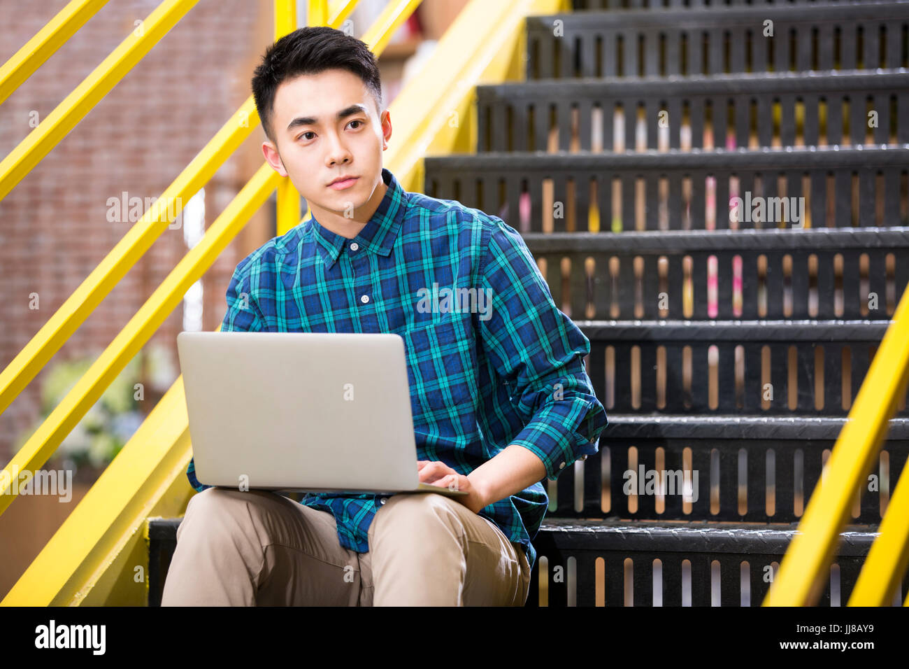 Young man work on the stairs Stock Photo - Alamy