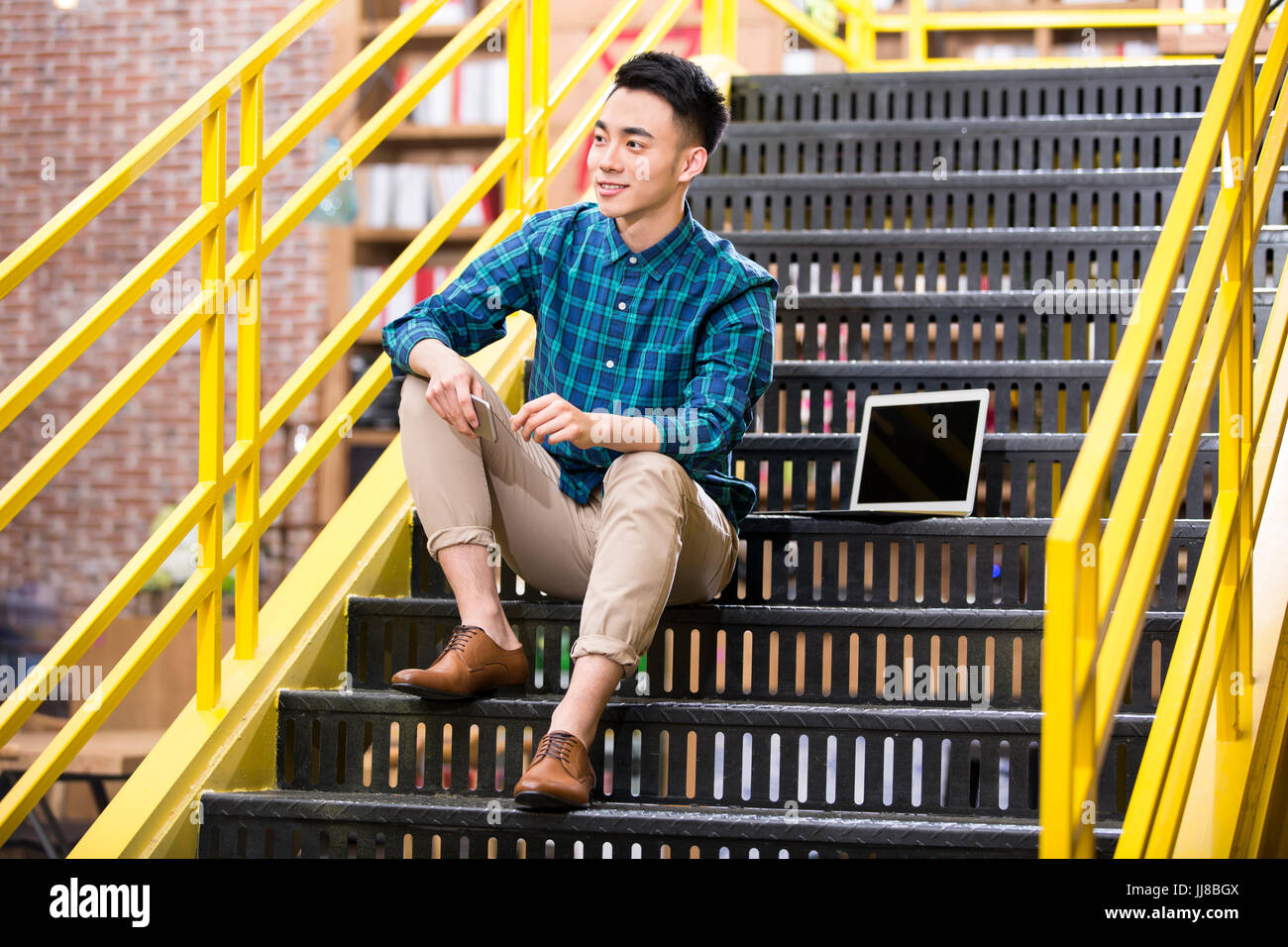 Young man on the stairs Stock Photo - Alamy