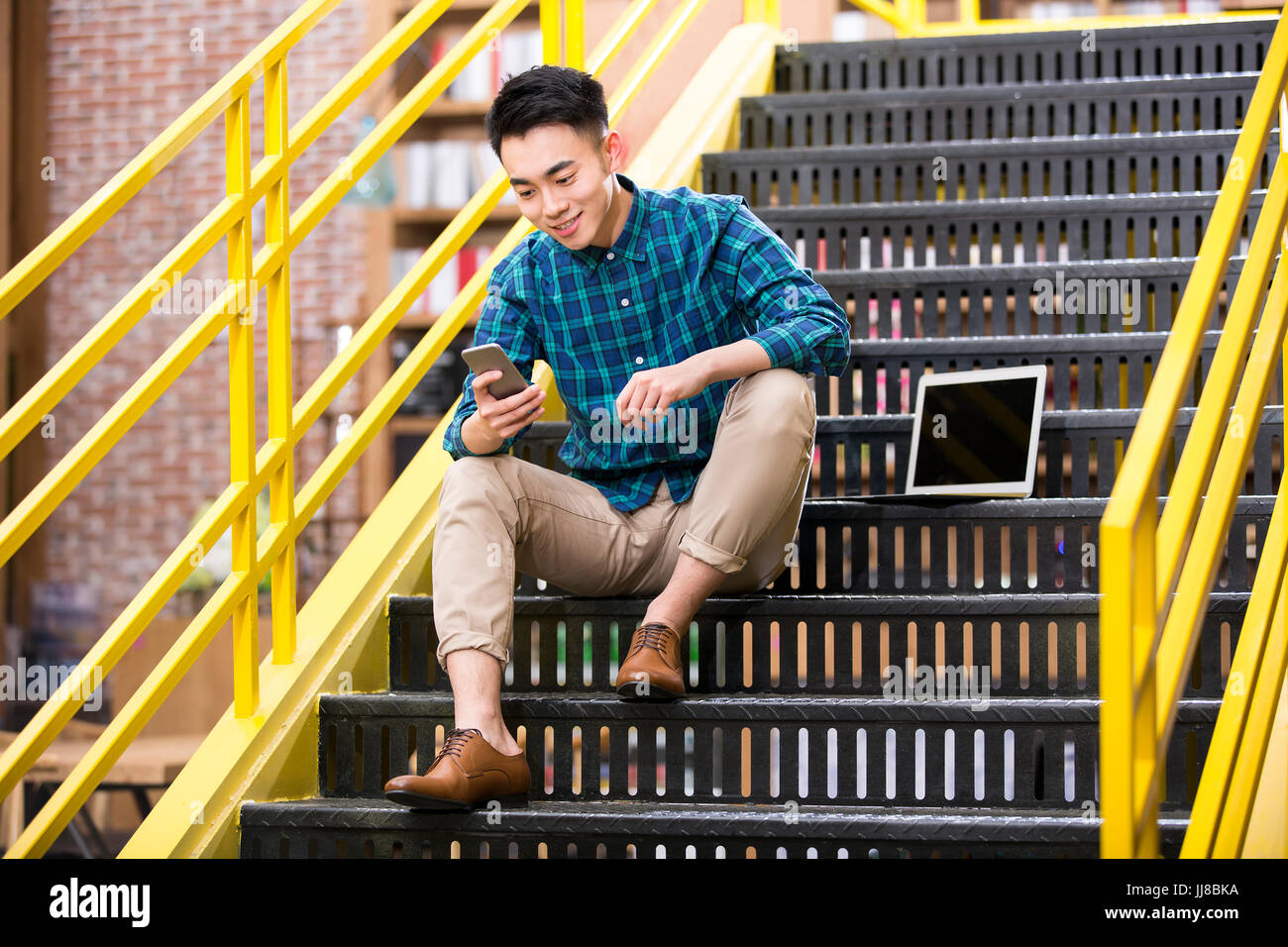 Young man on the stairs Stock Photo - Alamy
