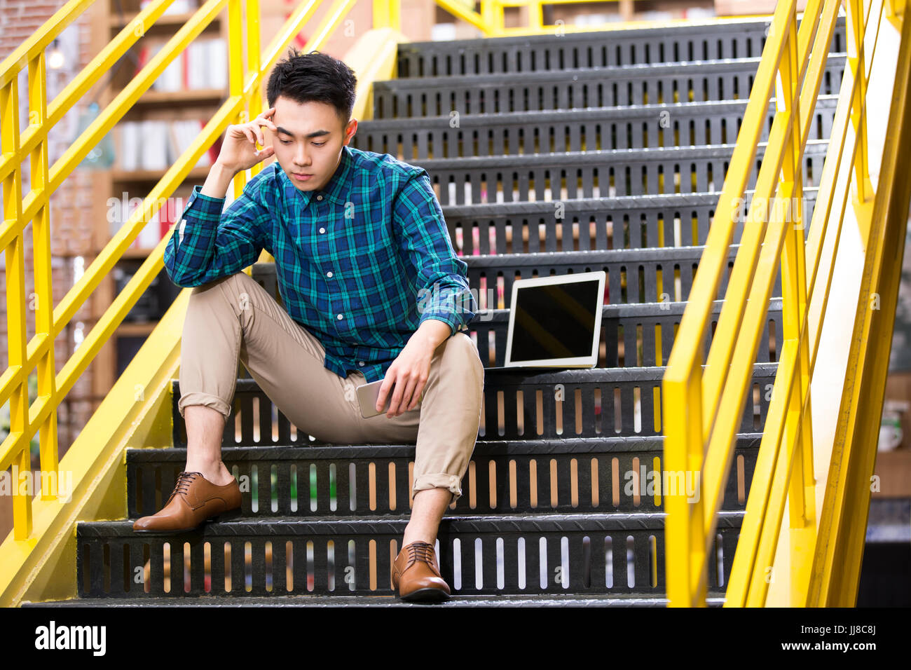 Young man on the stairs Stock Photo - Alamy