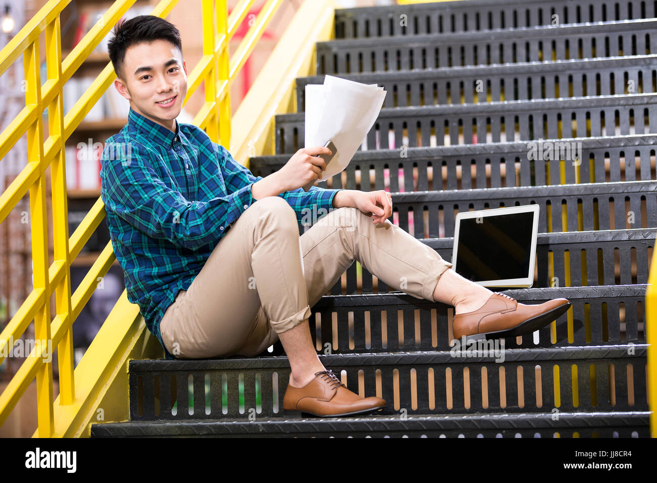 Young man work on the stairs Stock Photo - Alamy