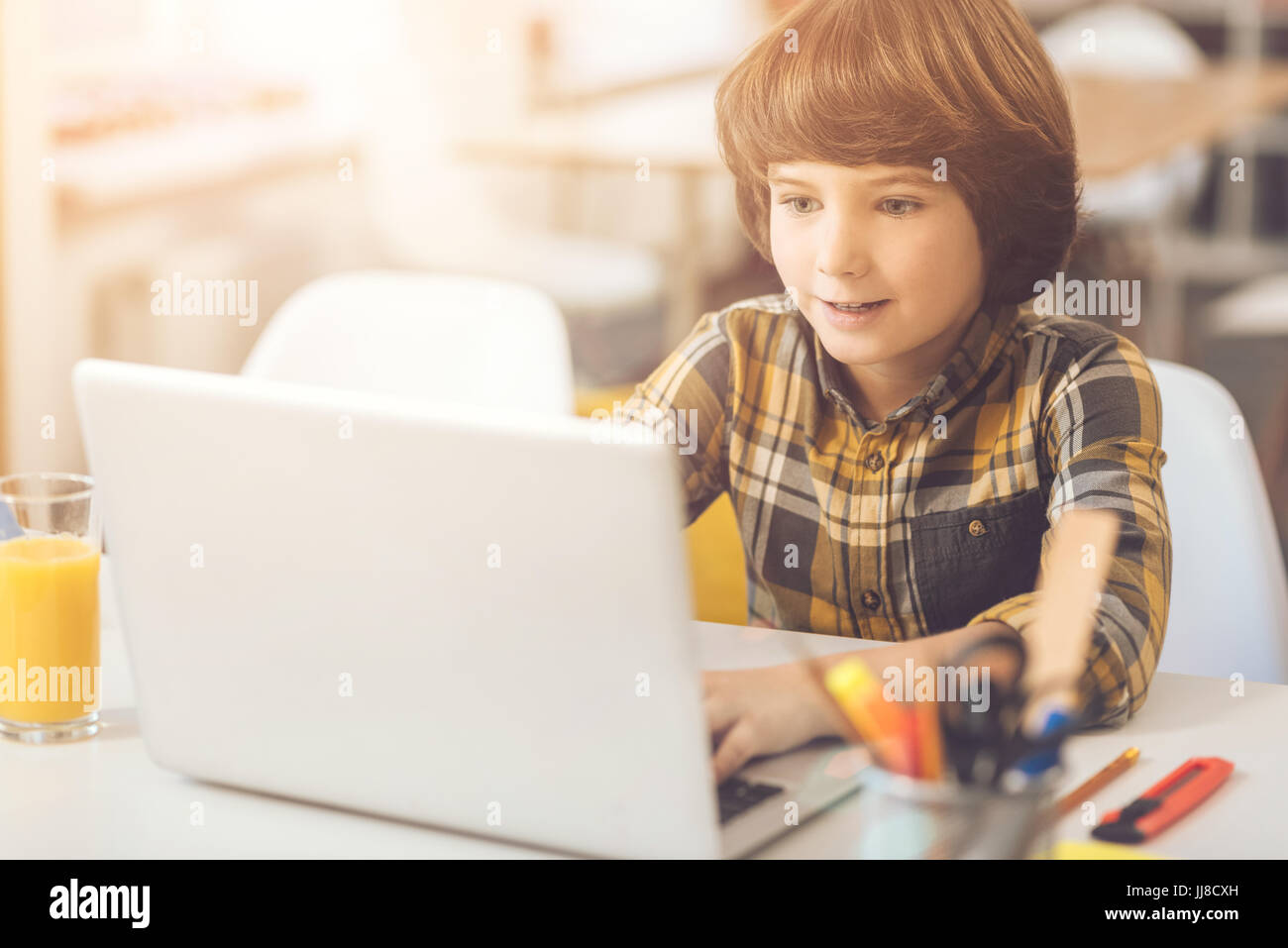 Cute smart kid playing computer games Stock Photo - Alamy