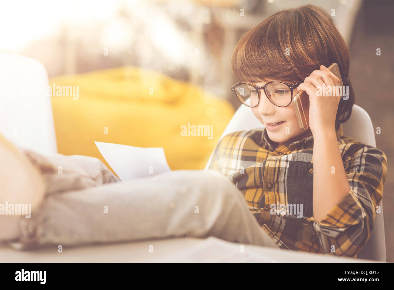 Positive cute boy speaking on the phone Stock Photo - Alamy