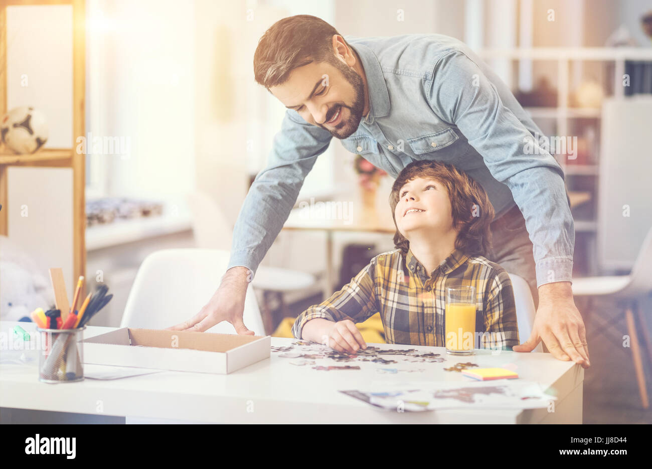 Joyful happy father standing behind his son Stock Photo - Alamy