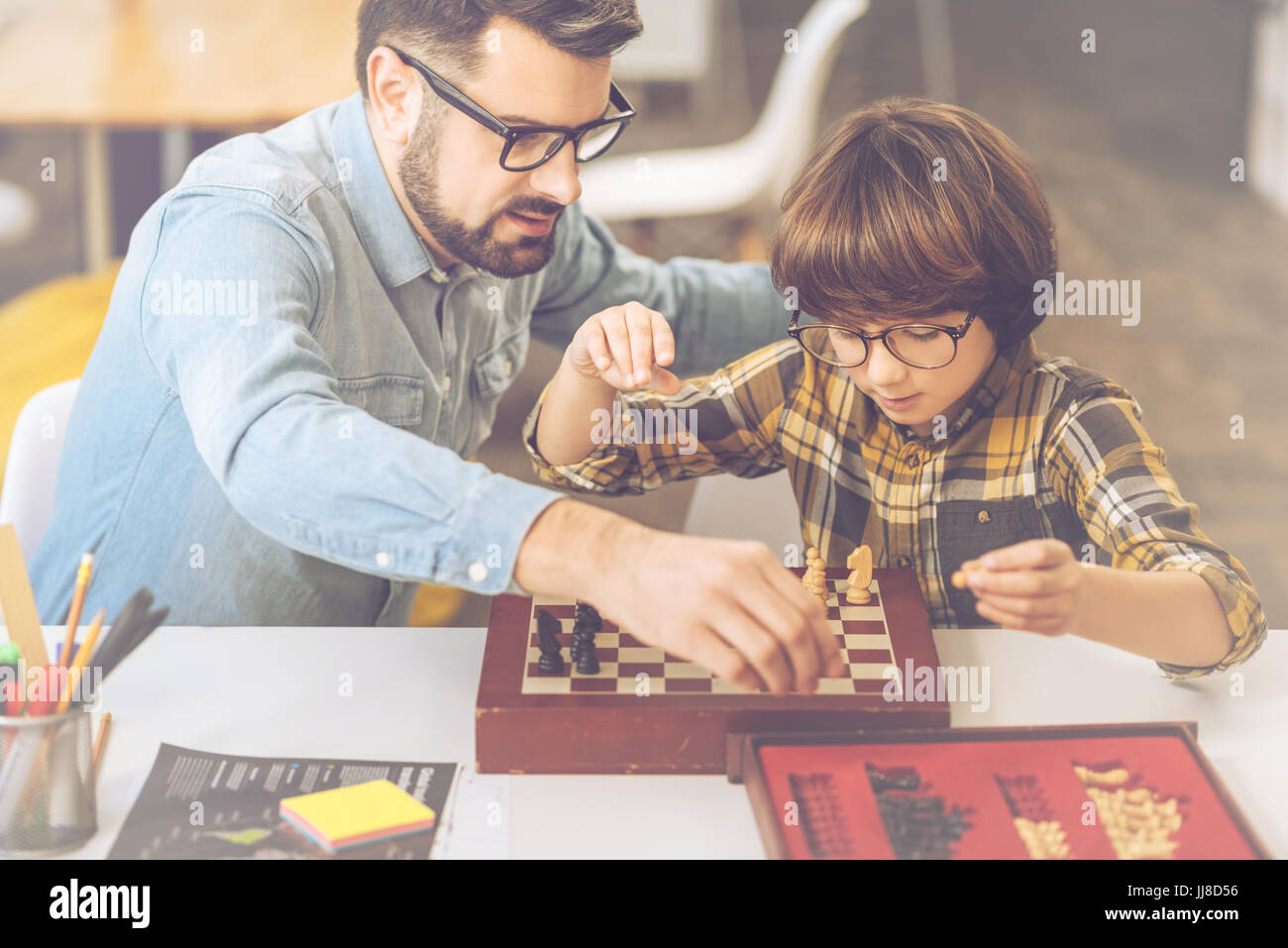 Father and son play chess hi-res stock photography and images - Alamy
