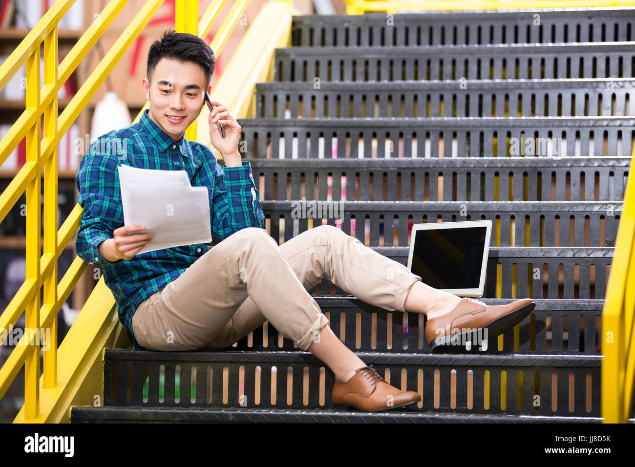 Young man work on the stairs Stock Photo - Alamy