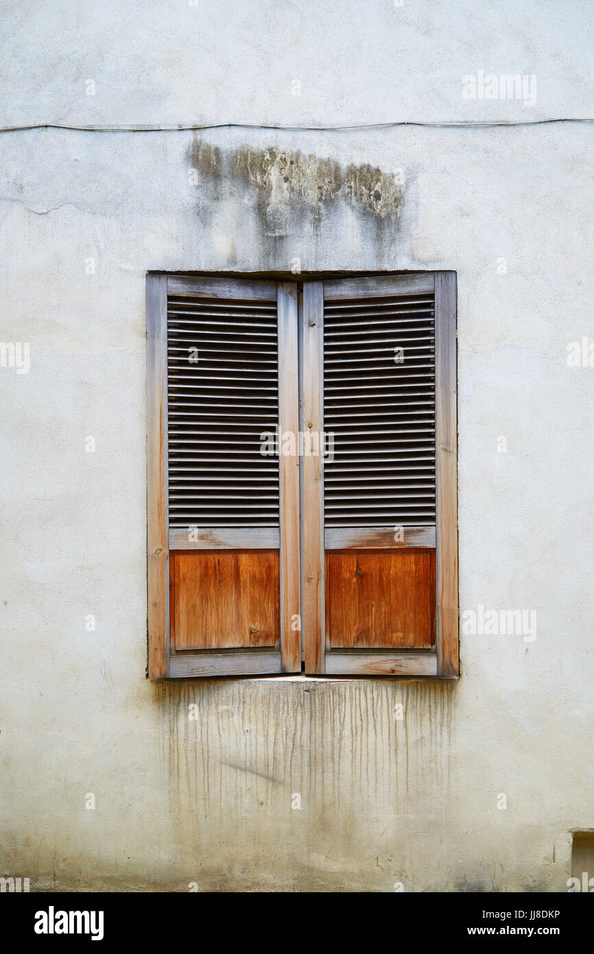 The old window covered with wooden shutters in the old town in Riga ...