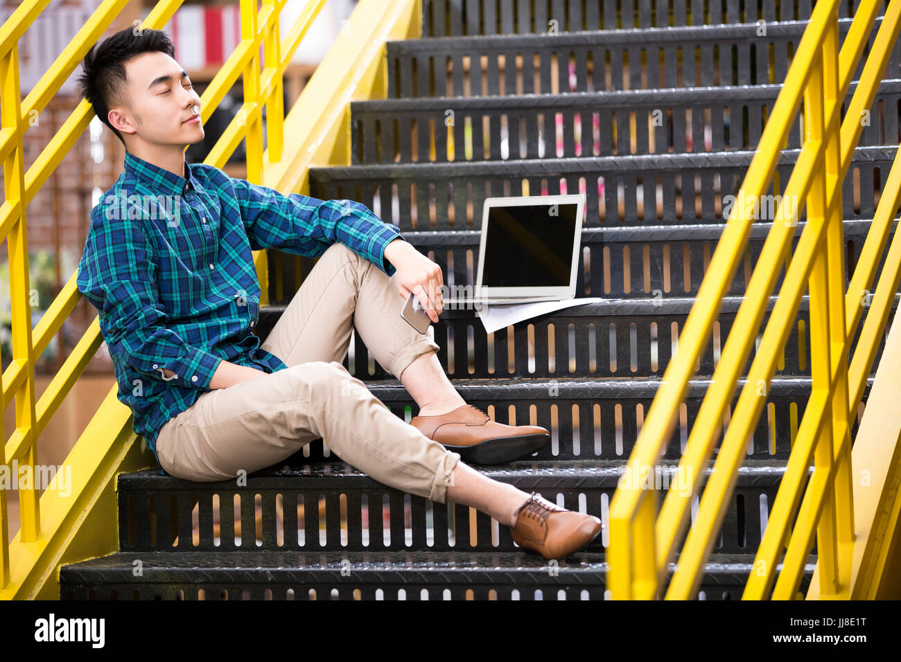 Young man on the stairs Stock Photo - Alamy