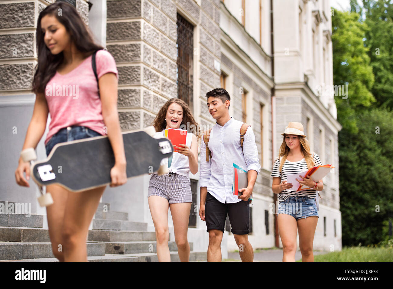 Group of attractive teenage students walking to university Stock Photo ...