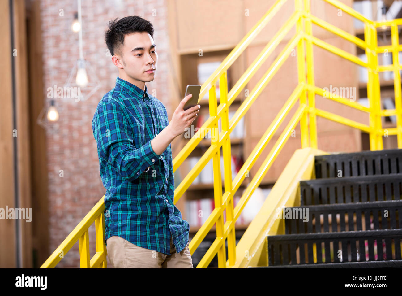 Young man using mobile phone Stock Photo - Alamy