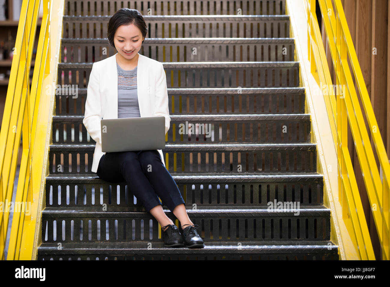 Business woman working on the stairs Stock Photo - Alamy