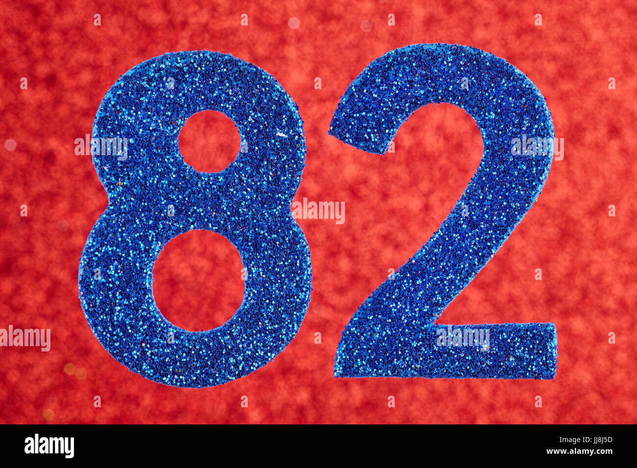 Number eighty-two blue color over a red background. Anniversary ...