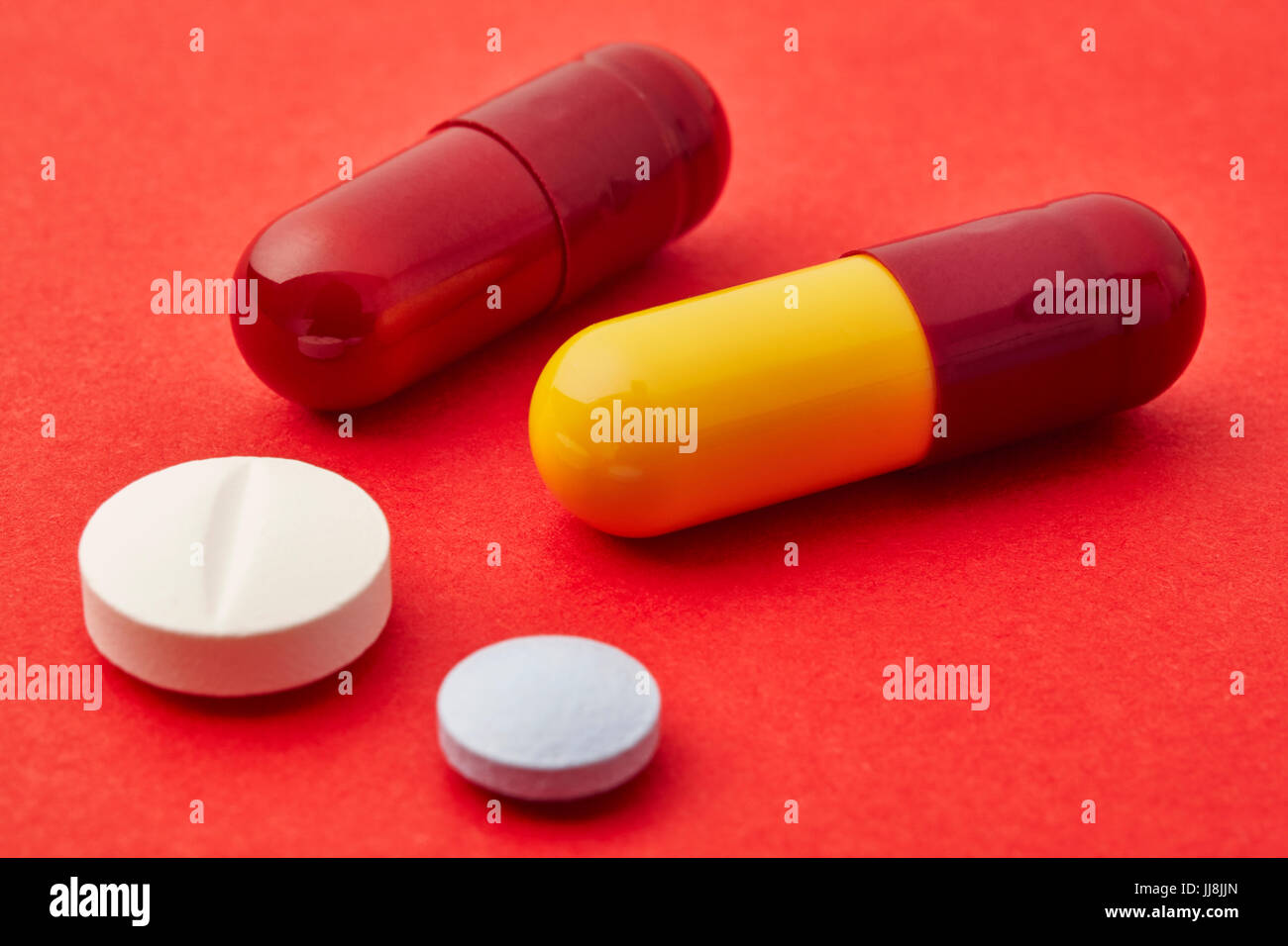 Pills over a red background. Medicament treatment. Health care photo ...