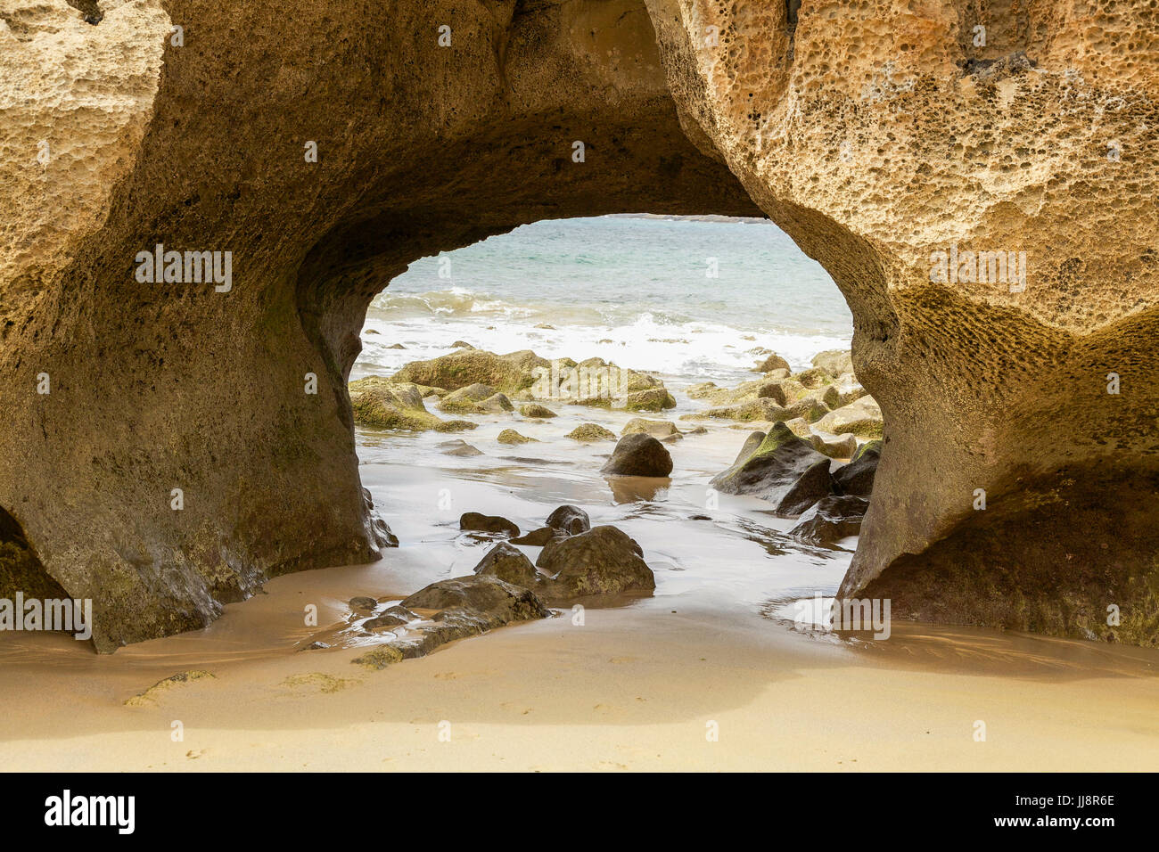 sandstone arch on the beach Stock Photo - Alamy