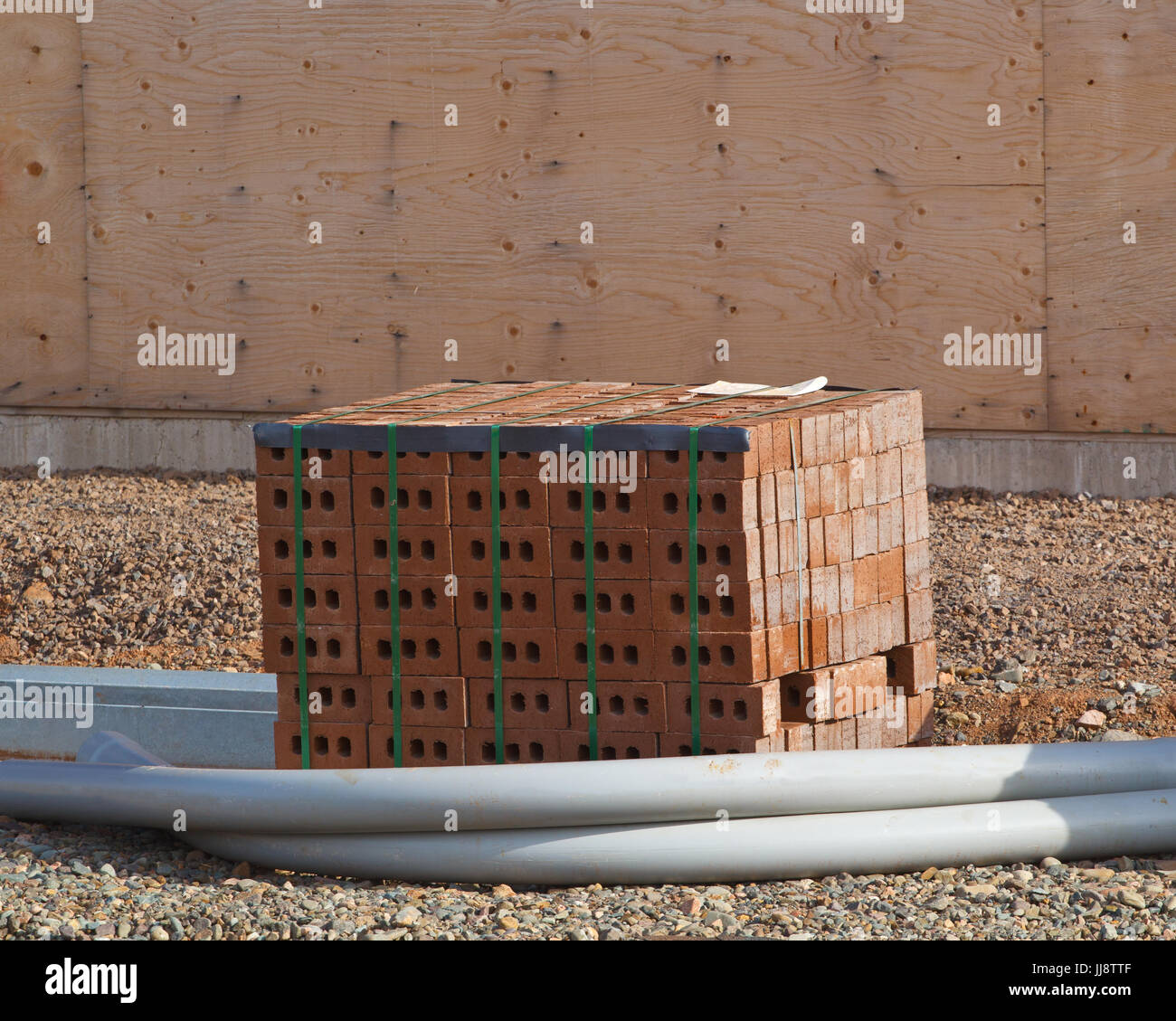 Bricks and conduit piping at construction site Stock Photo - Alamy