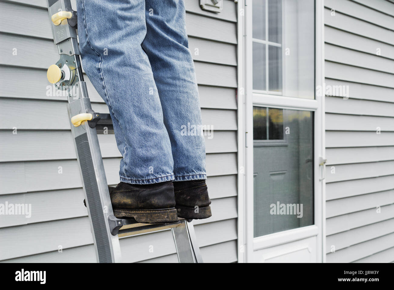 Man standing on ladder hi-res stock photography and images - Alamy