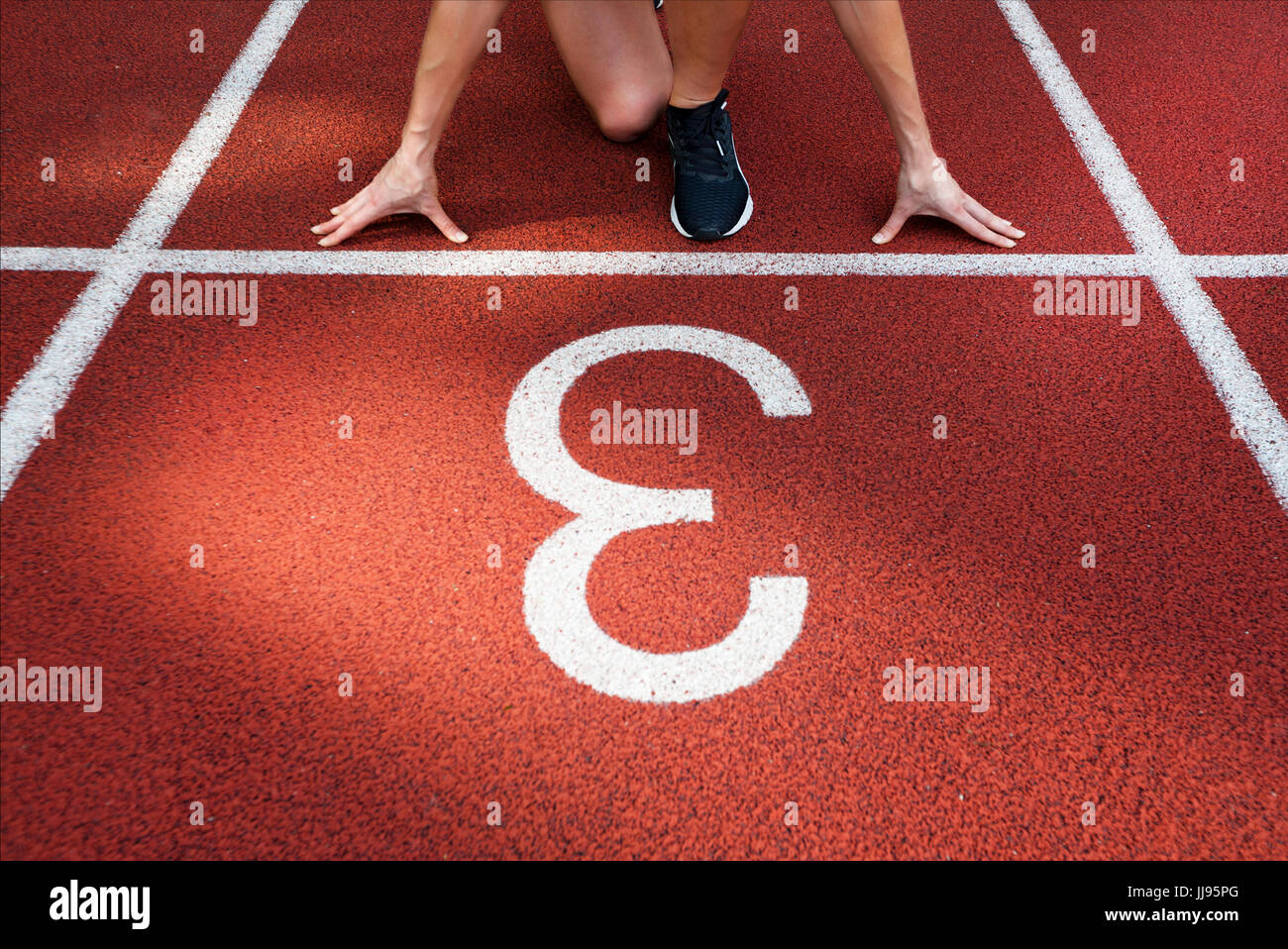 Athlete on starting line waiting for the start in running track Stock ...
